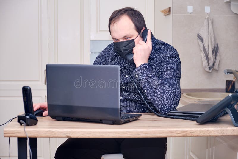 Office Phone Receiver in the Hands of a Man at a Work Table in the ...