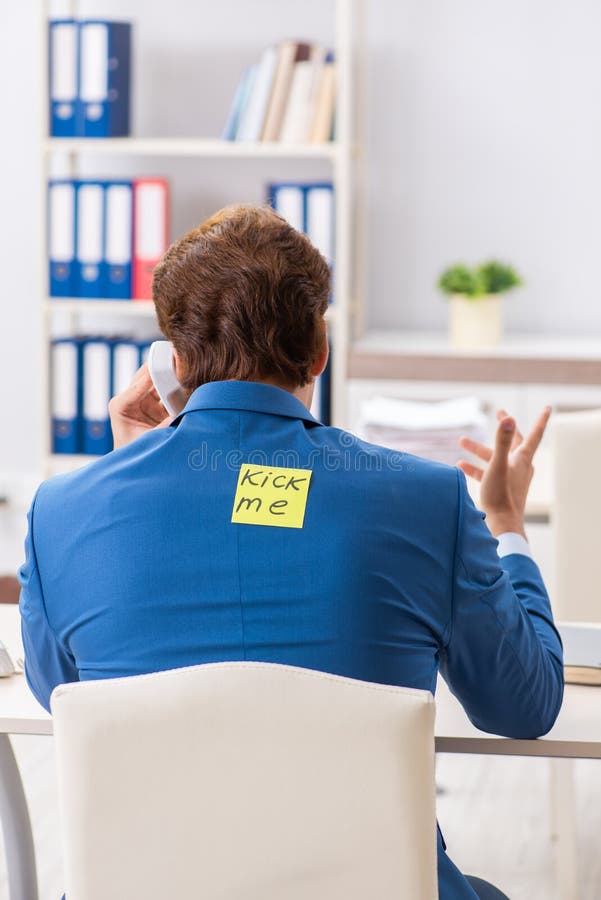 The Office Prank with Kick Me Message on Sticky Note Stock Photo ...