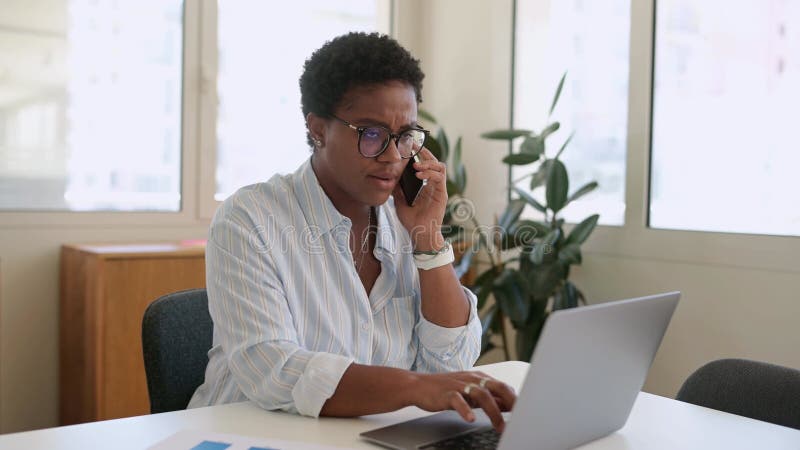 An Office Professional is Engrossed in Conversation on Smartphone while ...