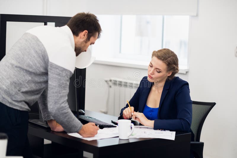 Office Routine. Two Office Workers, a Man and a Woman, Discussin Stock ...
