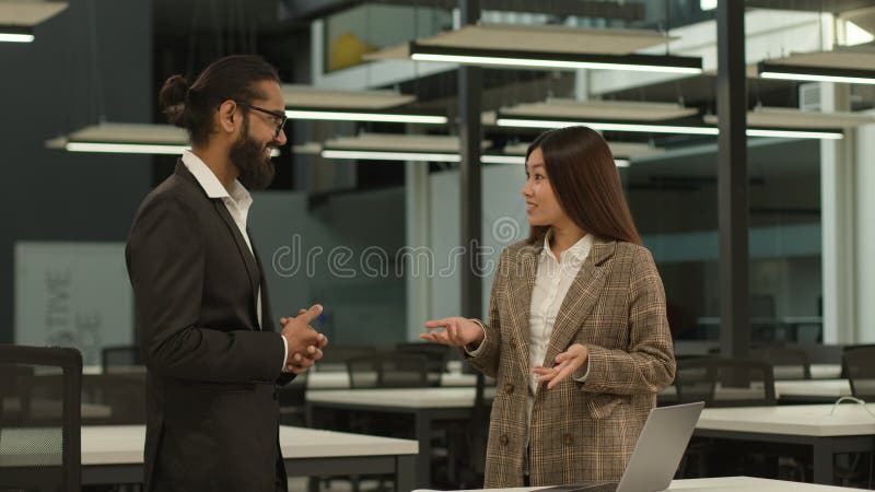 A Man and Woman are Conversing in an Office Setting Stock Photo - Image ...