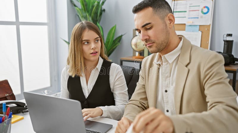 In an Office Setting, a Professional Man and Woman Work Together ...