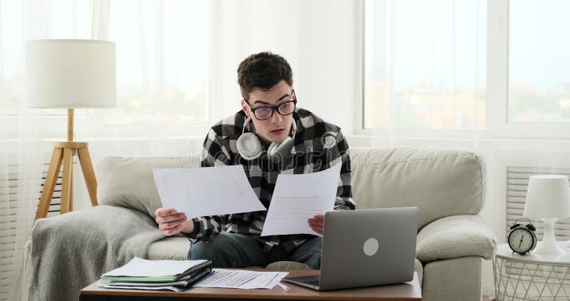 Young Man Organizing Work Documents on Office Sofa Stock Video - Video ...