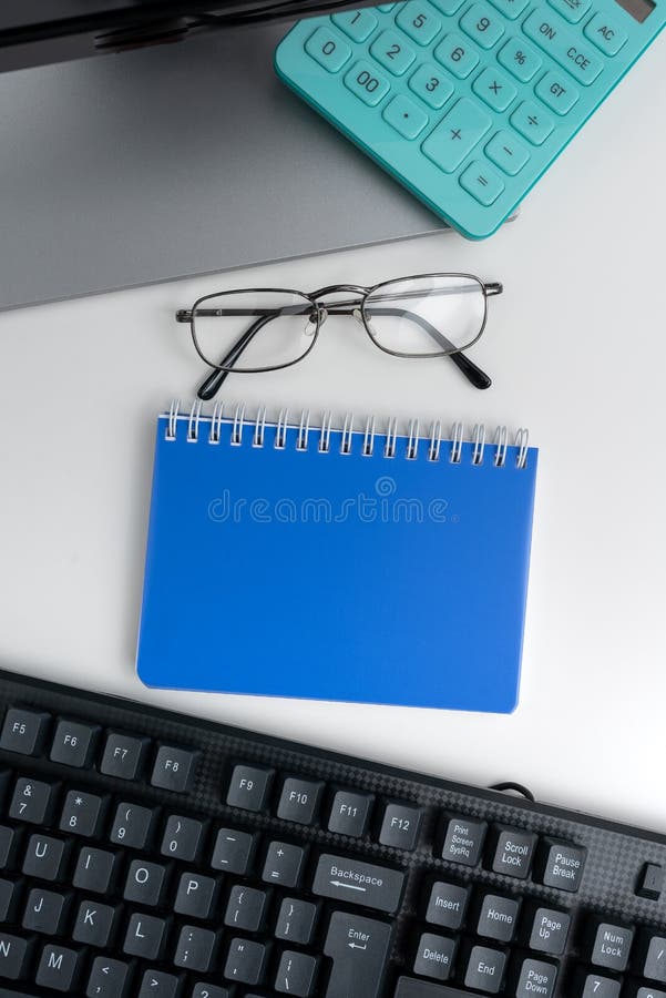 Office Supplies Over Desk with Keyboard and Glasses and Coffee Cup for ...