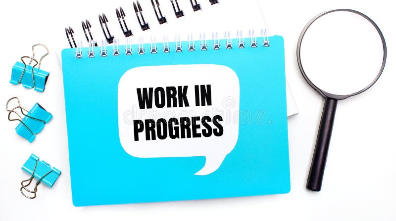 Office Table with Blue Notepad, Paper Clips, Magnifying Glass and White ...