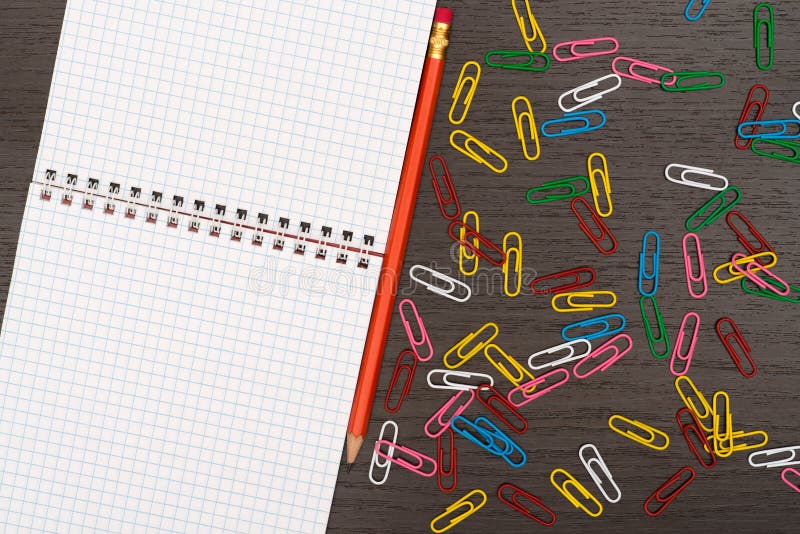 Office Table with Notebook, Pencils and Paper Clips. Stock Photo ...