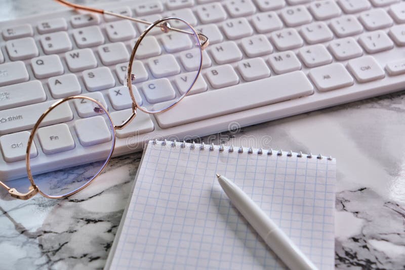 Office Table with Notepad, Eyeglasses, Keyboard and Notepad Stock Image ...
