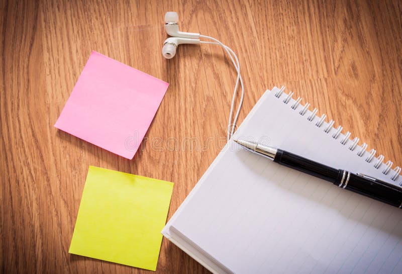 Office Table with Notepad, Pen , Headphone, Sticky Notes Stock Image ...