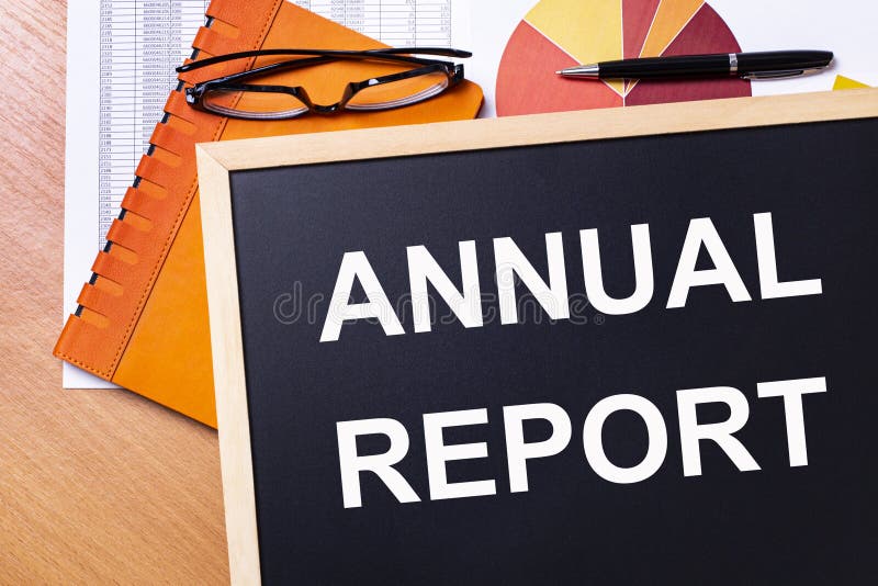 On the Office Table is an Orange Notepad, Black Glasses, a Pen and a ...