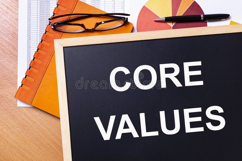 On the Office Table is an Orange Notepad, Black Glasses, a Pen and a ...