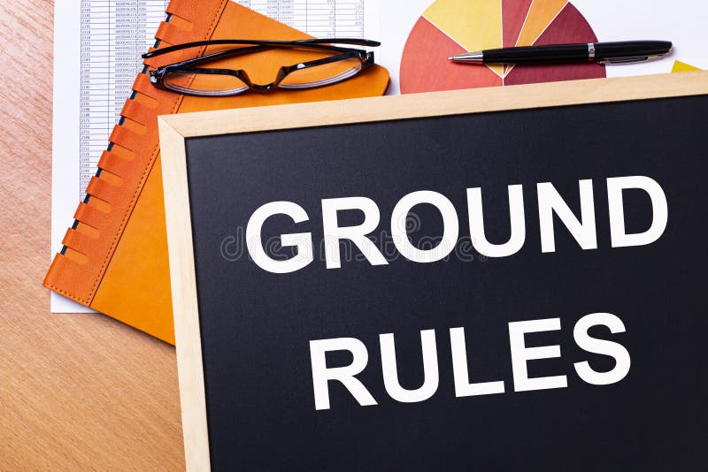 On the Office Table is an Orange Notepad, Black Glasses, a Pen and a ...