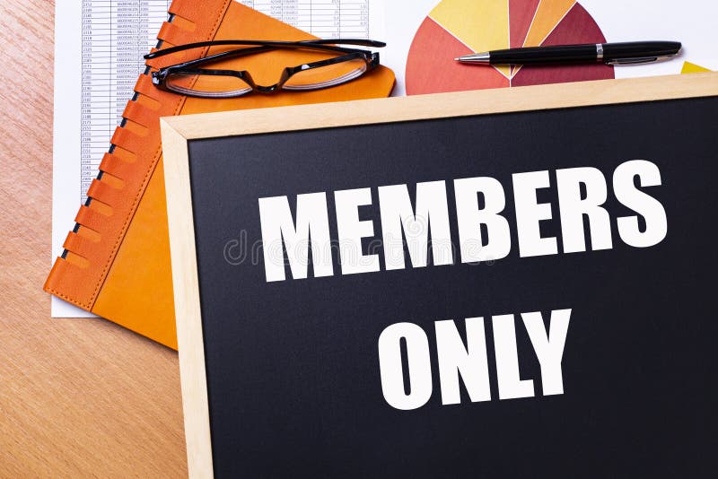 On the Office Table is an Orange Notepad, Black Glasses, a Pen and a ...