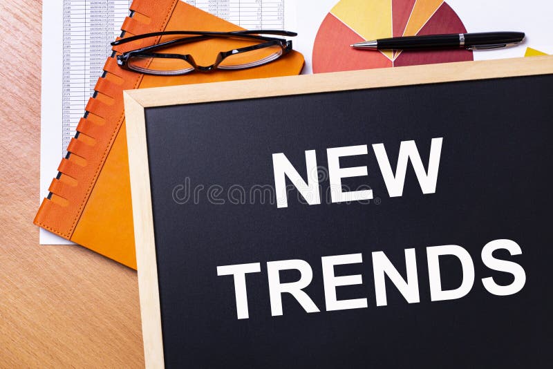 On the Office Table is an Orange Notepad, Black Glasses, a Pen and a ...