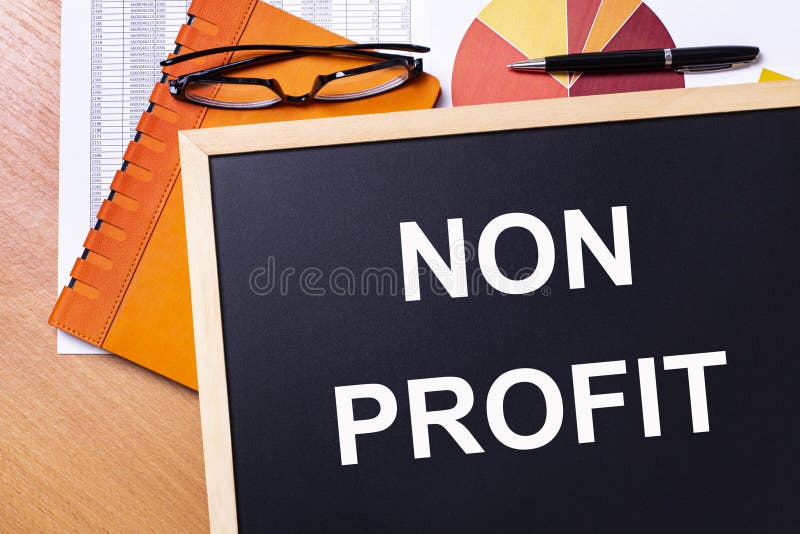 On the Office Table is an Orange Notepad, Black Glasses, a Pen and a ...