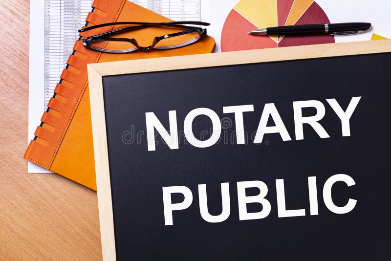 On the Office Table is an Orange Notepad, Black Glasses, a Pen and a ...