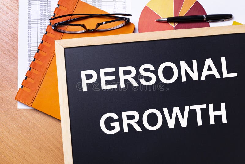 On the Office Table is an Orange Notepad, Black Glasses, a Pen and a ...