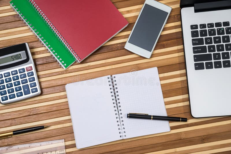 Office Table Workspace with Laptop, Notepad, Pen, Phone and Calculator ...