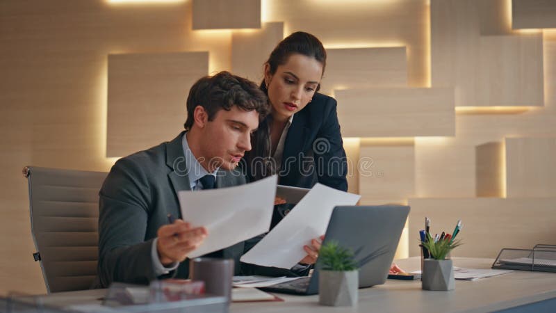 Office Team Watching Papers Working Together at Computer Workplace ...