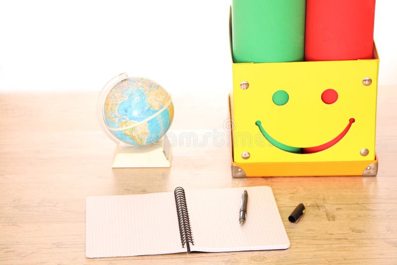 In the Office There is a Yellow Box with Documents and a Globe on the ...