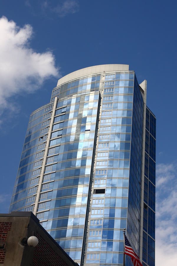 Office Tower with American Flag Reflecting Clouds Stock Image - Image ...