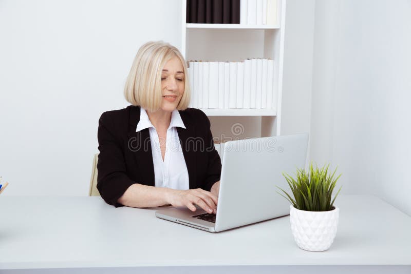 Office Woman Typing at Her Laptop at Her Workplace. Stock Image - Image ...