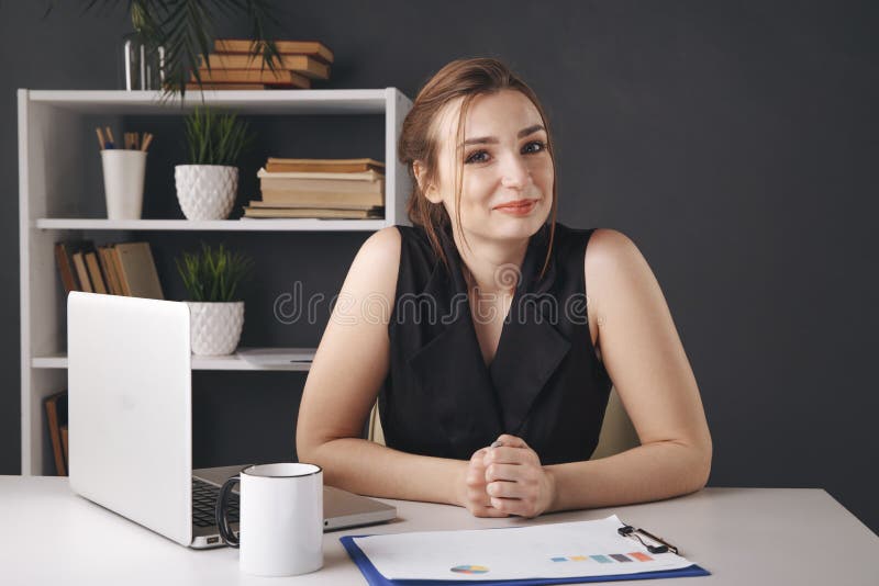 Office Woman Working on the Computer Sitting and Smiling. Stock Image ...