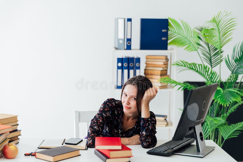 Office Worker Bored at the Desk at the Books and Computer Stock Photo ...