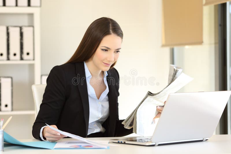 Office Worker Comparing Online Content with a Newspaper Stock Photo ...