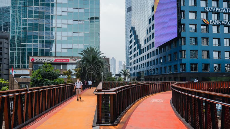 An Office Worker is Crossing Using a Pedestrian Bridge during the Day ...