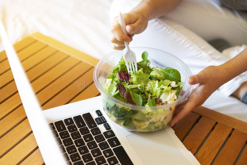 Office Worker Eating A Takeaway Salad At Work. Concept Of Healthy ...