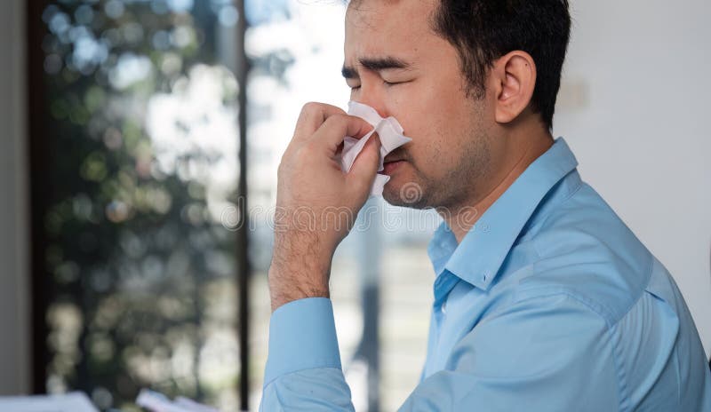 Office Worker Feeling Unwell with Cold Symptoms at Desk in Modern ...