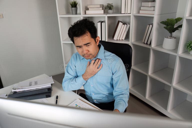 Office Worker Feeling Unwell at Desk with Cold Symptoms in Modern ...