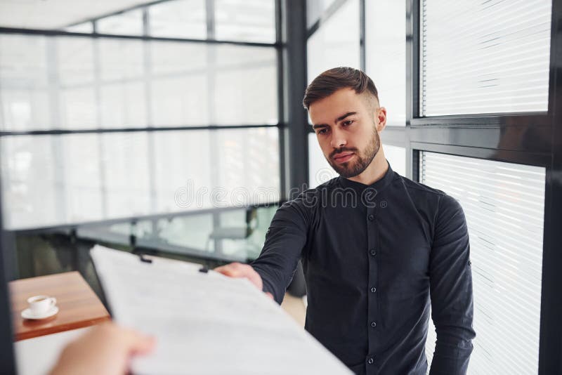Office Worker in Formal Clothes Standing Indoors at Daytime Stock Photo ...