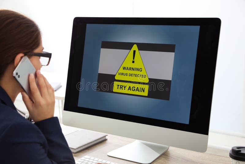 Office Worker in Front of Computer with Warning about Virus Attack on ...