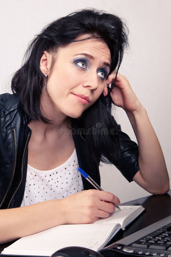 Office Worker Girl Working on a Computer and Does Records in a Diary ...