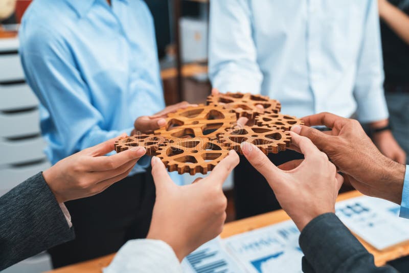 Office Worker Holding Cog Wheel As Unity and Teamwork in Workplace ...