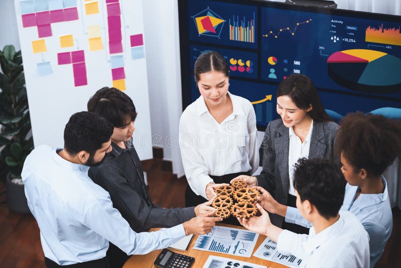 Office Worker Holding Cog Wheel As Unity and Teamwork in Workplace ...