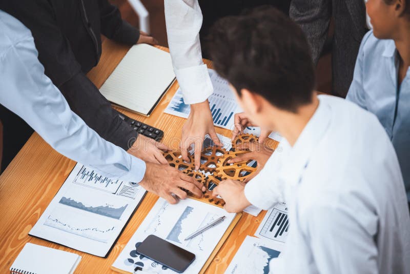 Office Worker Holding Cog Wheel As Unity and Teamwork in Workplace ...