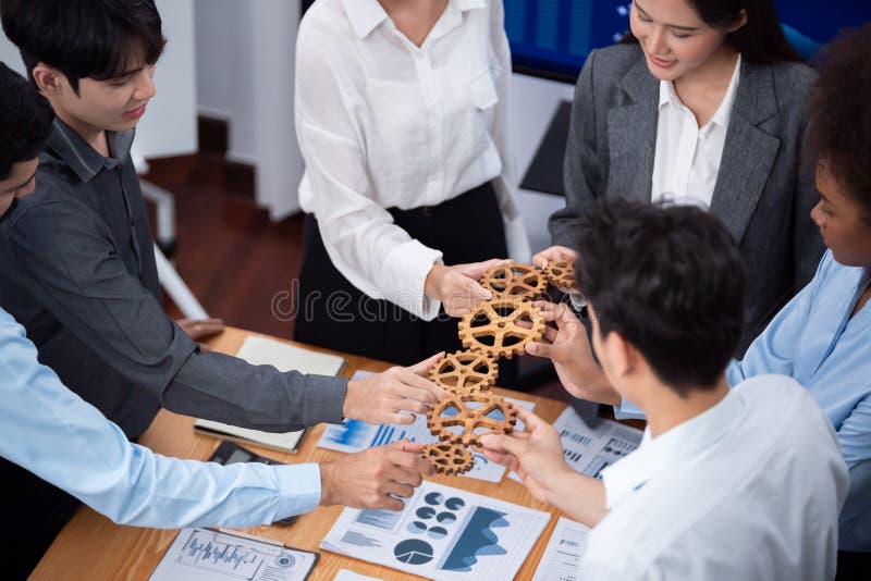 Office Worker Holding Cog Wheel As Unity and Teamwork in Workplace ...