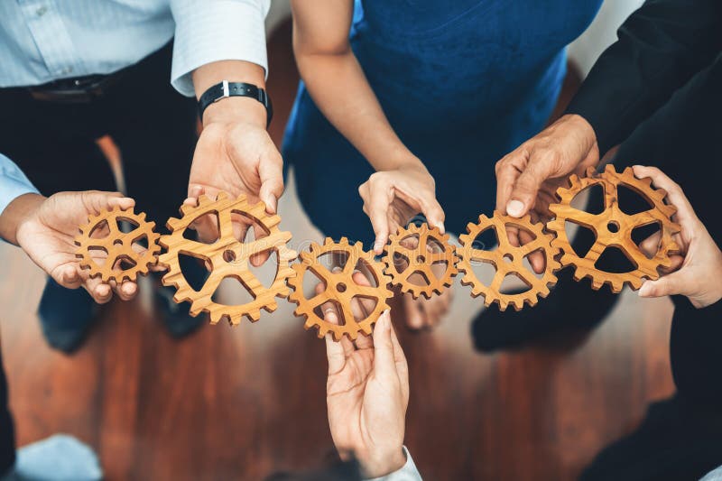 Office Worker Holding Cog Wheel As Unity and Teamwork in Workplace ...