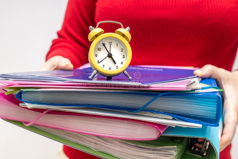 Office Worker Holding a Pile of Documents with an Alarm Clock, Concept ...