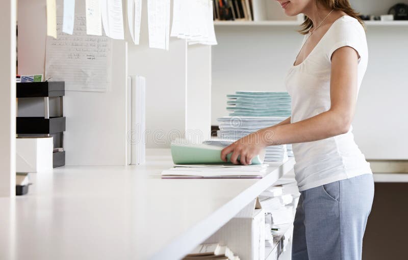 Office Worker Holding Sorting Paper Materials Standing in Office Stock ...