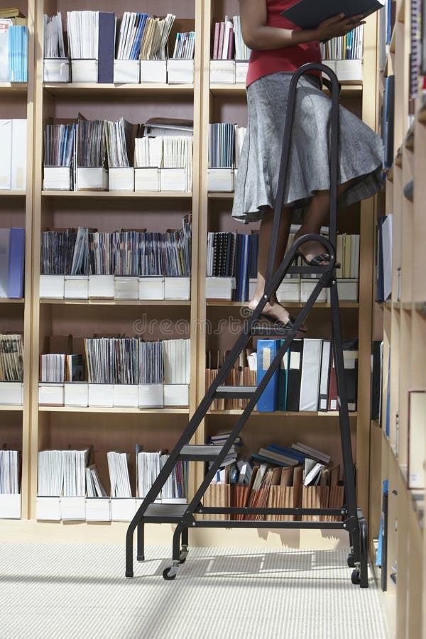 Office Worker on Ladder in File Storage Room Stock Photo - Image of ...