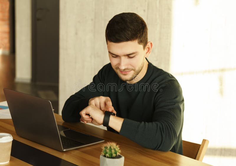 Office Worker at Laptop Checking Time Sitting in Office Stock Image ...
