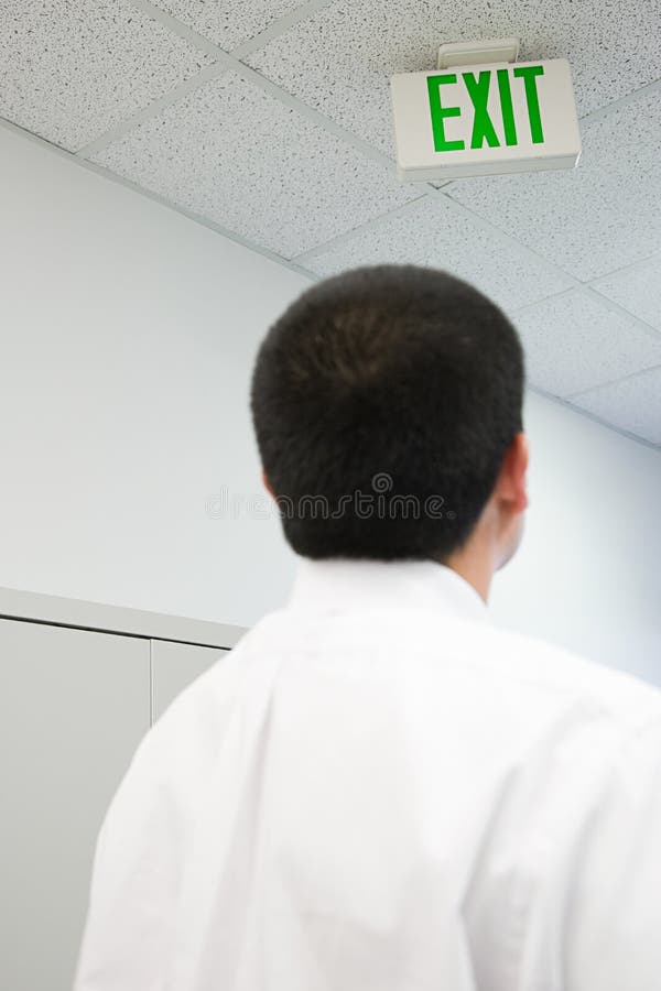 Office Worker Looking at Exit Sign Stock Photo - Image of indoors ...