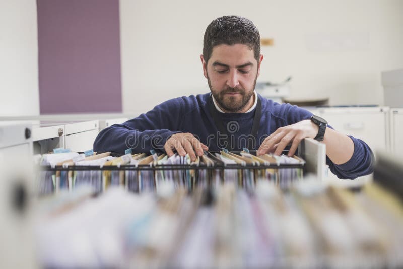Office Worker Looking Files at Drawer in Office Stock Image - Image of ...