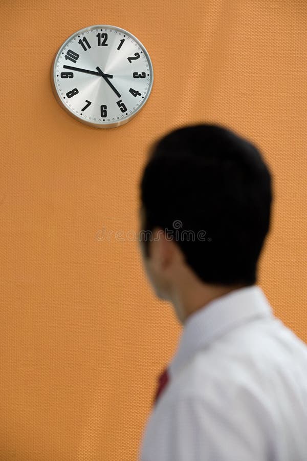Office Worker Looking at a Wall Clock Stock Photo - Image of bored ...