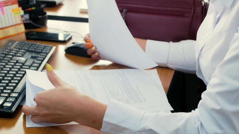 Office Worker Looks through Documents. Preparing Documents for the ...