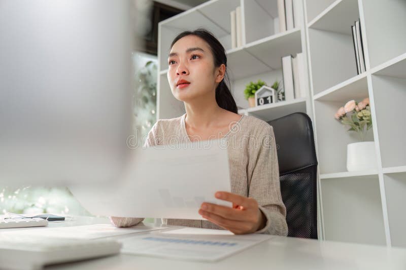 Concentrated Office Worker Contemplating Data and Reports while ...