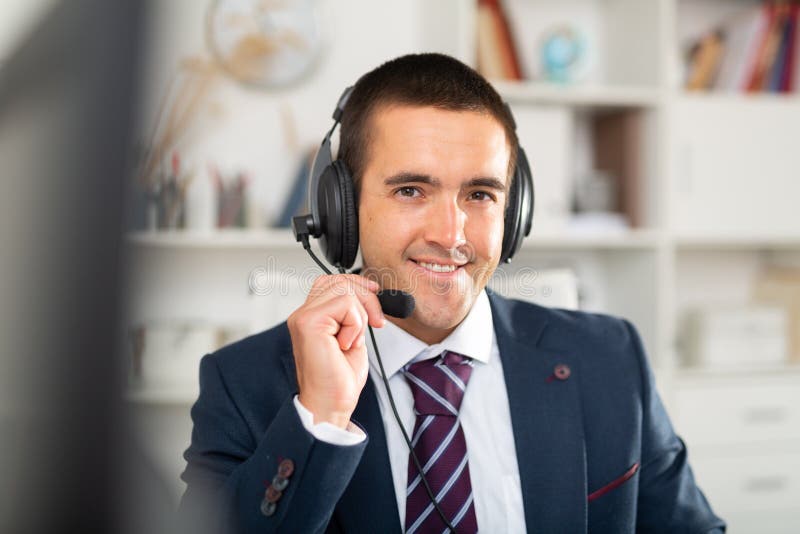 Office Worker Man is Working at Computer and Talking by Headset with ...